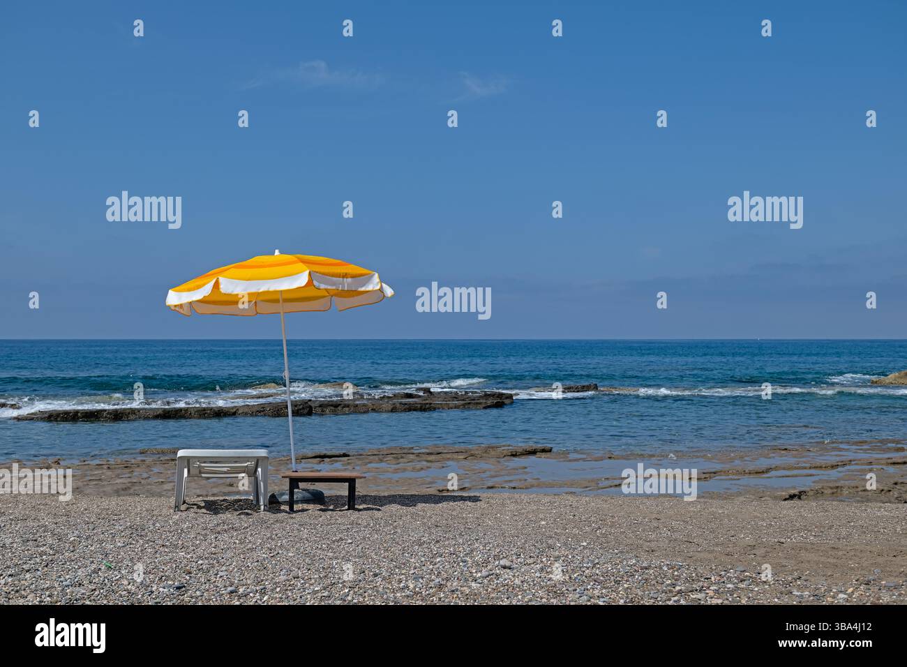 Yellow colored parasols and sunbeds on the beach Stock Photo - Alamy