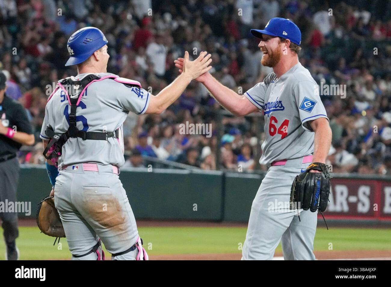 Los Angeles Dodgers catcher Will Smith, left, high-fives pitcher Matt ...
