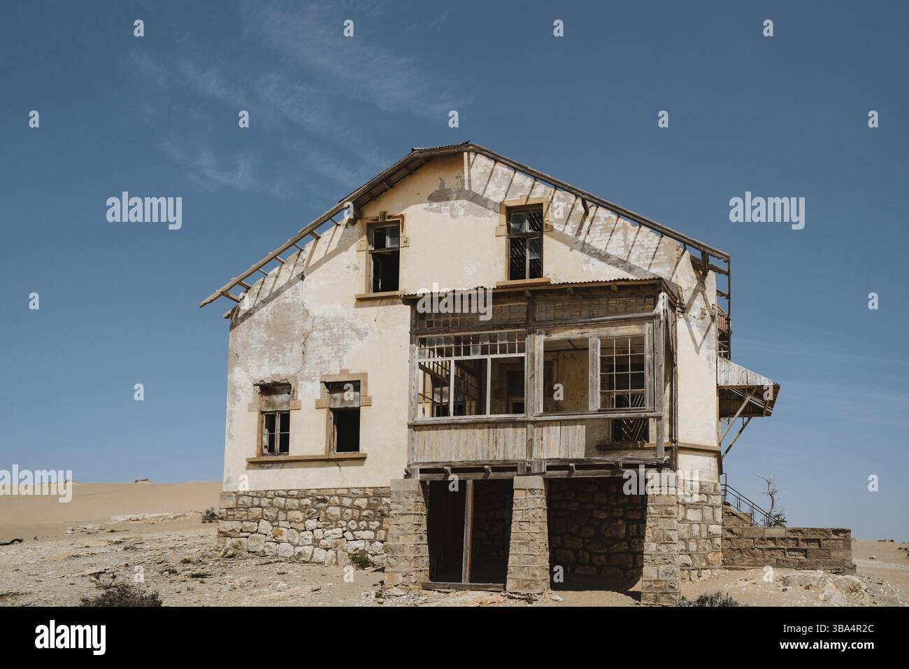 Wideangle photo an abandoned big house on a high desert plain in Africa ...