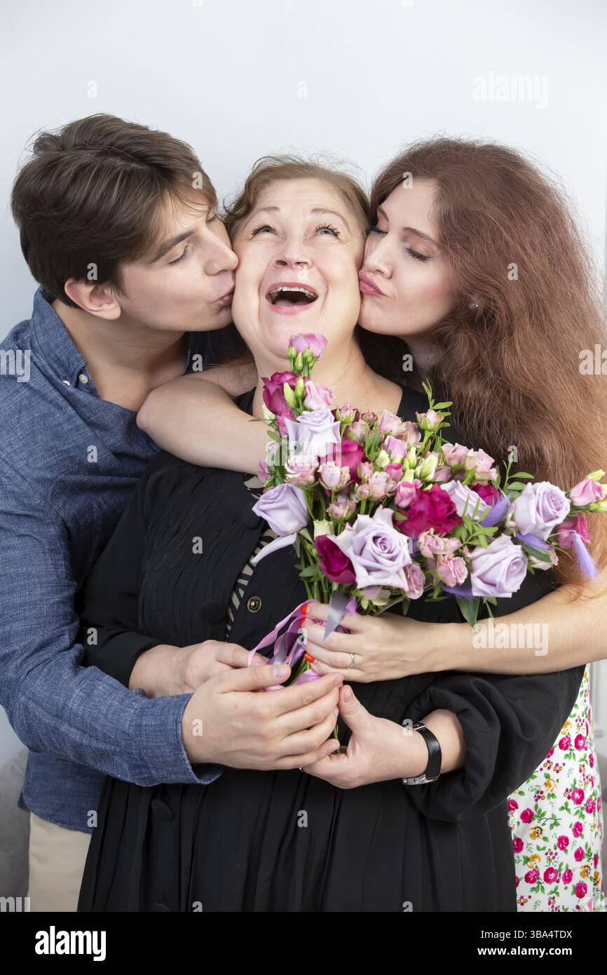 Holiday at the woman. Elderly woman with a bouquet of flowers ...