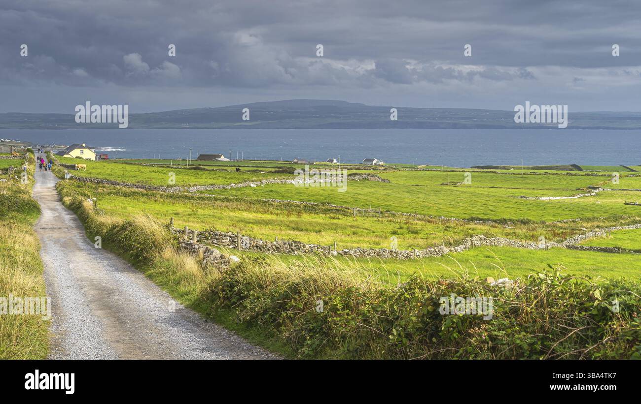 Tourists walking down the country road from popular attraction, iconic ...