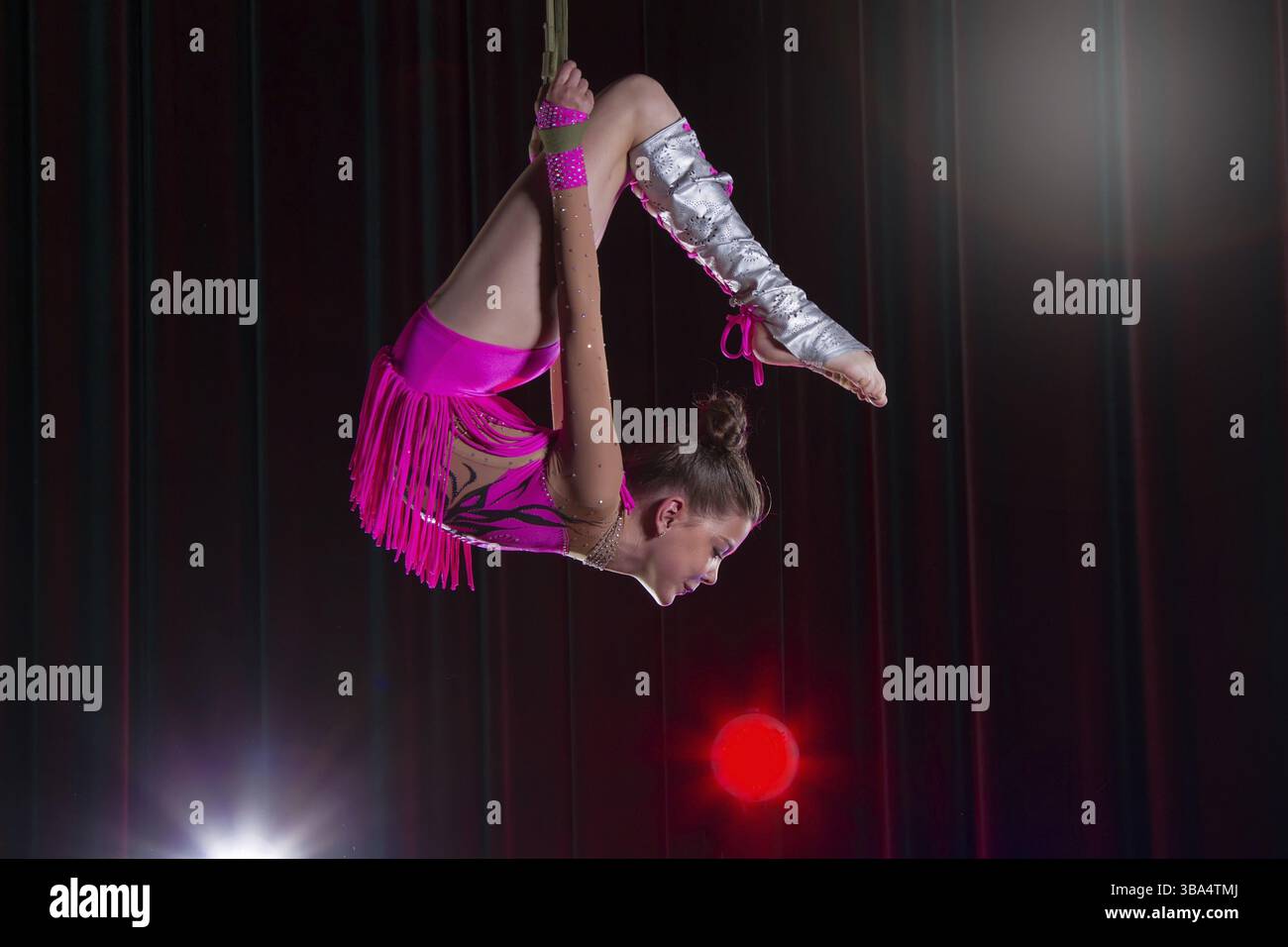 Circus artist acrobat performance. The girl performs acrobatic elements ...