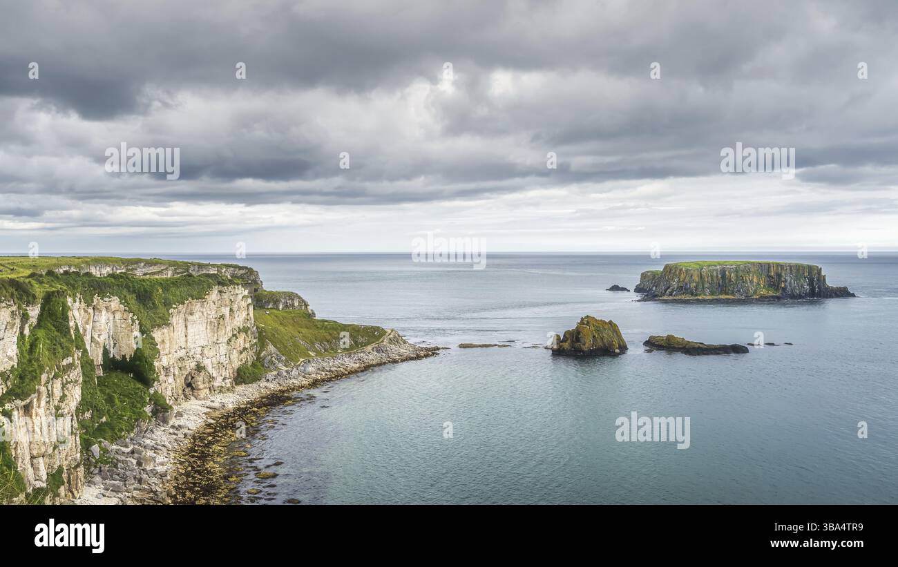 Tall limestone cliffs and Sheep Island near Carrick a Rede rope bridge ...