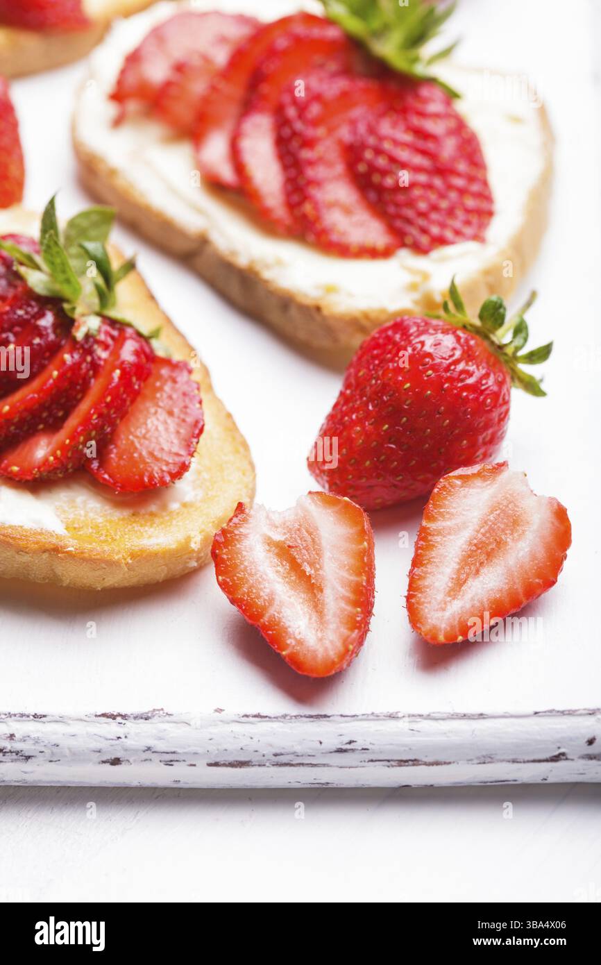 Summer breakfast - toasts with butter and strawberry Stock Photo - Alamy