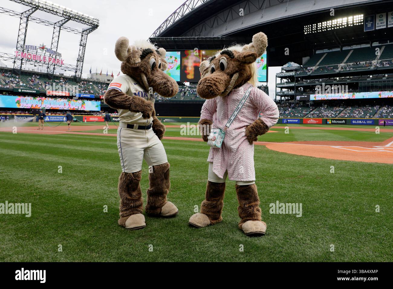 Seattle Mariners' mascot Mariner Moose, left, poses with a likeness ...