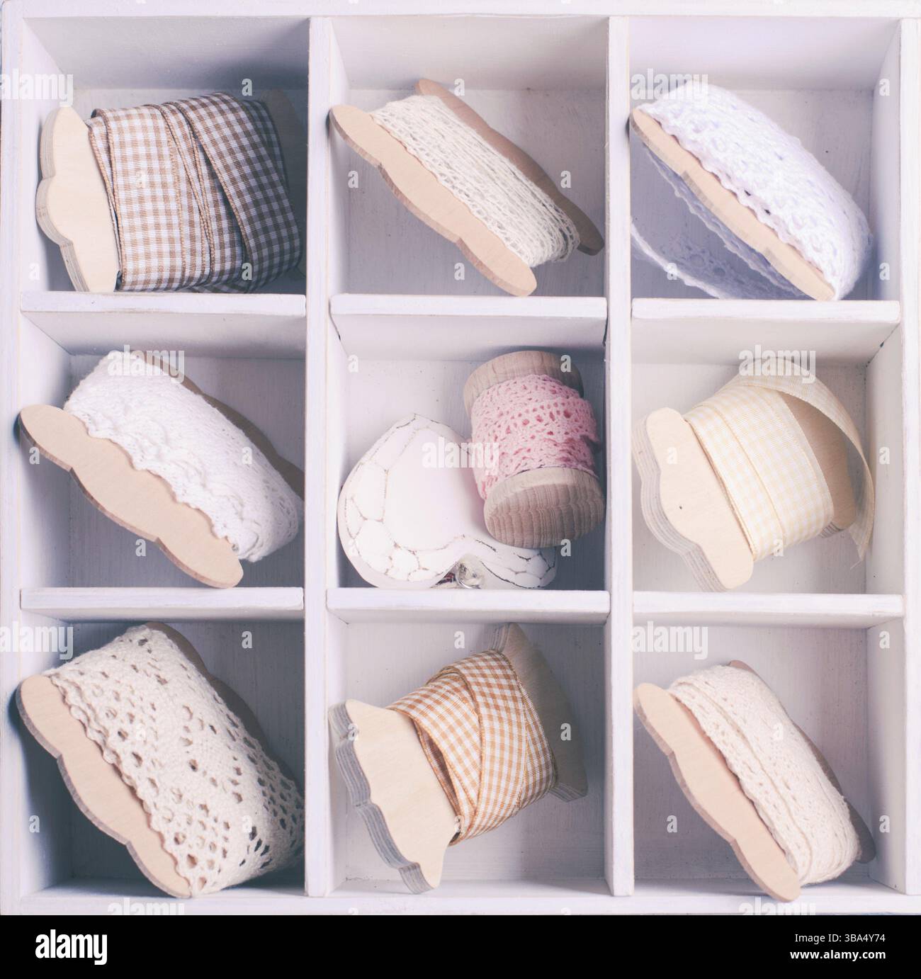 Vintage lace wooden bobbin in the cells of white shabby box Stock Photo ...