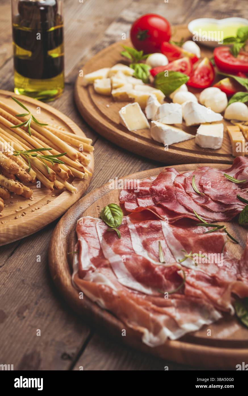 Italian appetizer - various types of ham, cheese and grissini Stock ...