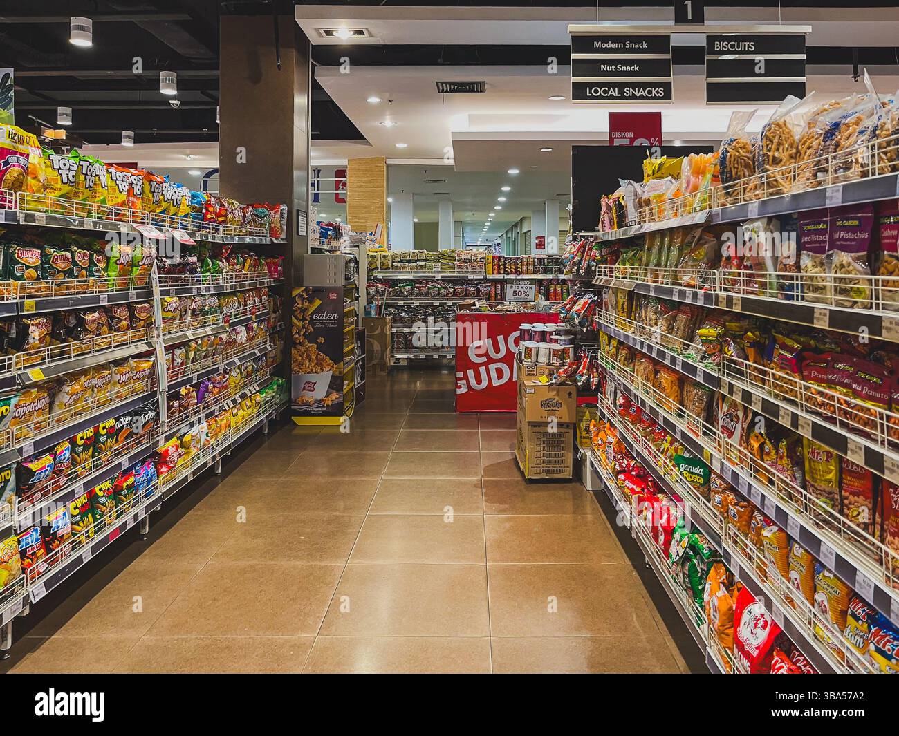 Balikpapan, Indonesia – April 13th 2025: A brightly lit snack aisle in ...
