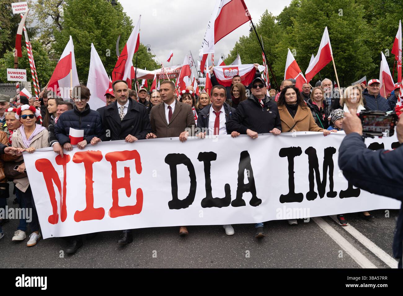 Protesters hold a banner saying "No to Migration" as they take part in ...