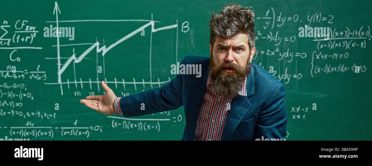 Teacher explains math at blackboard. Professor in classroom with ...