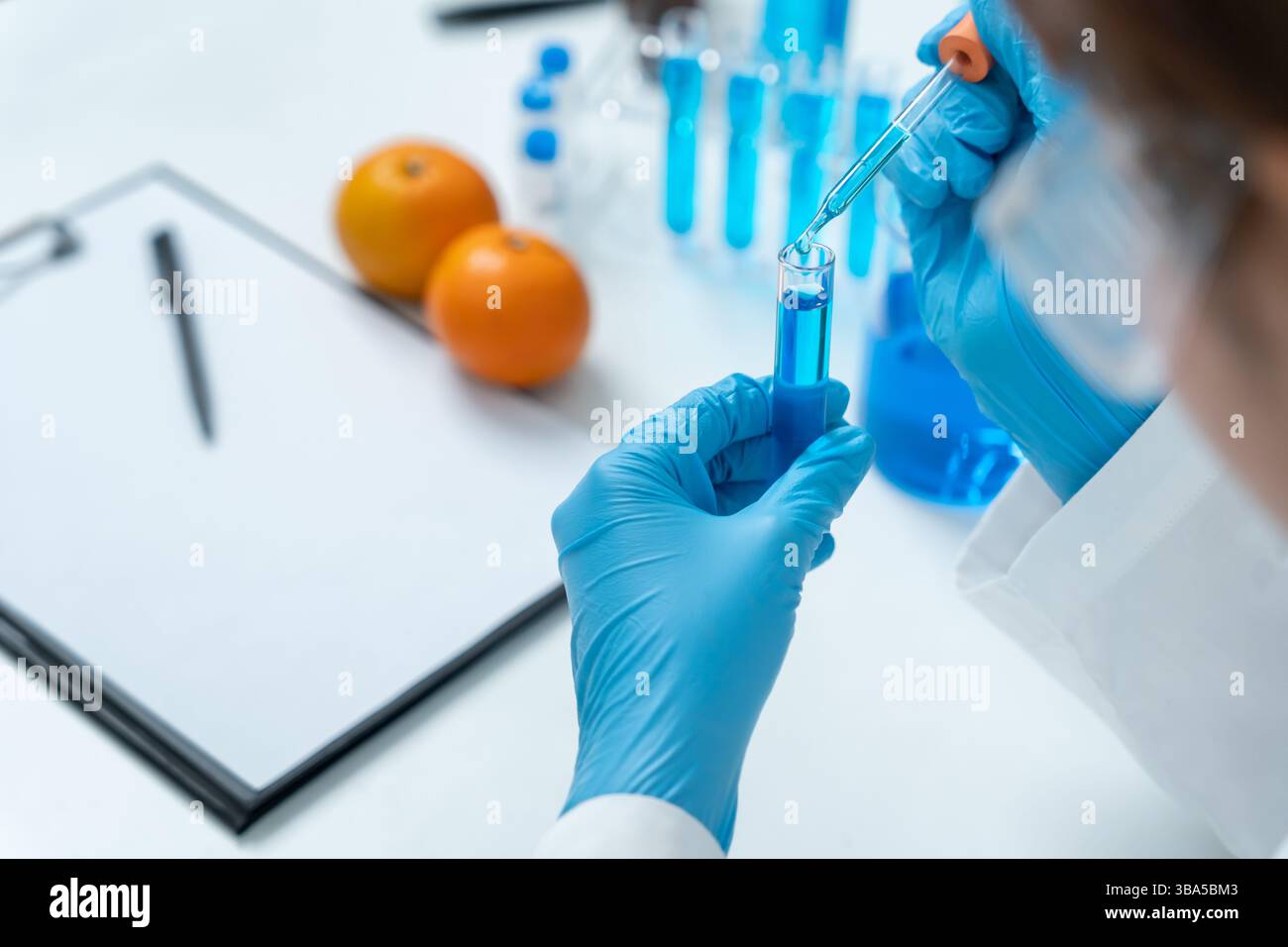 Scientist check chemical fruit residues hi-res stock photography and ...