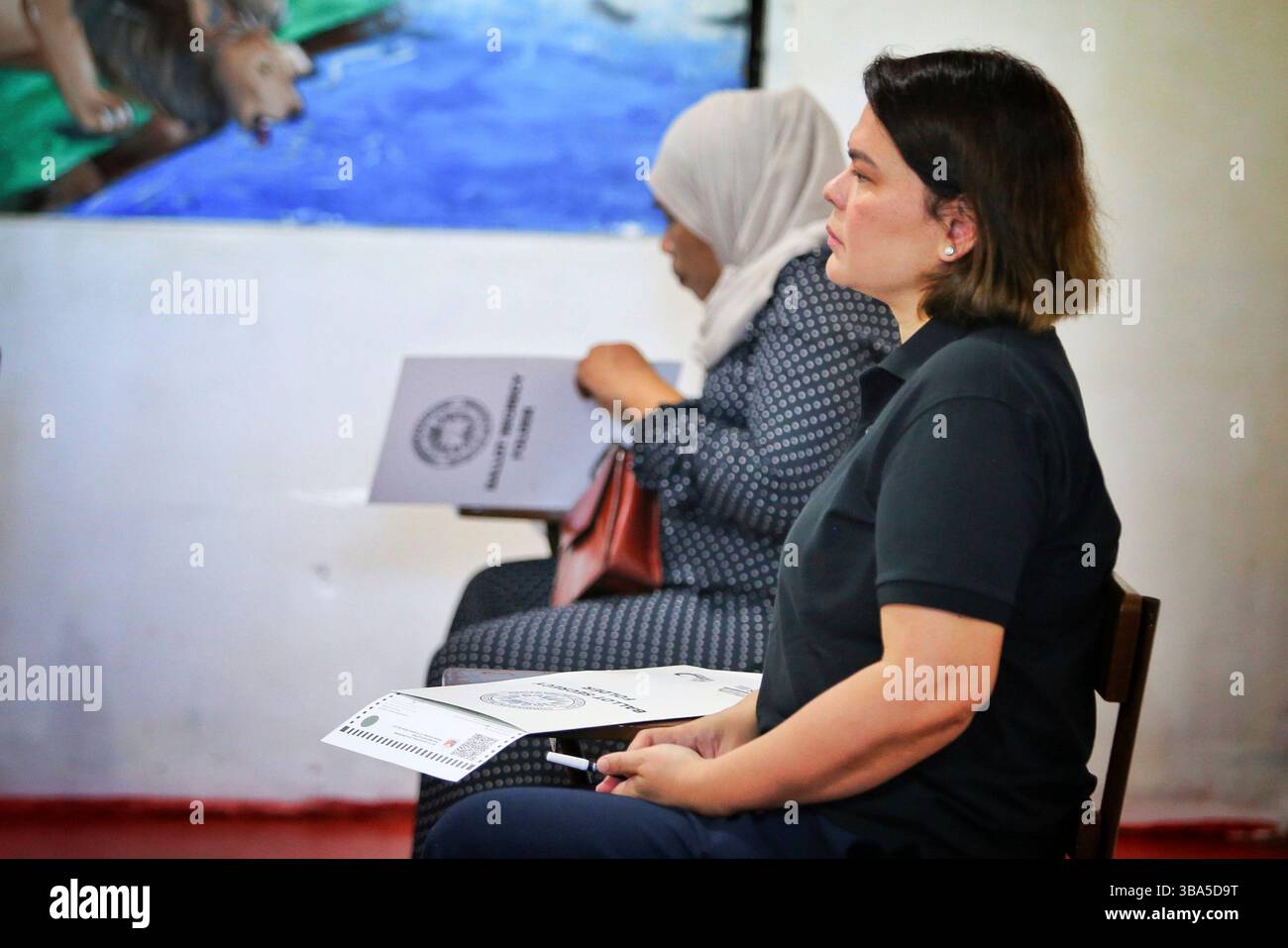 Philippine Vice President Sara Duterte casts her vote at a polling ...