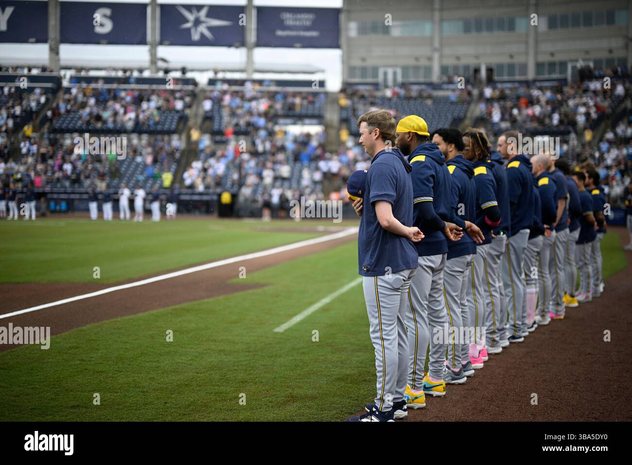 Milwaukee Brewers players and staff, right, stand for the national ...