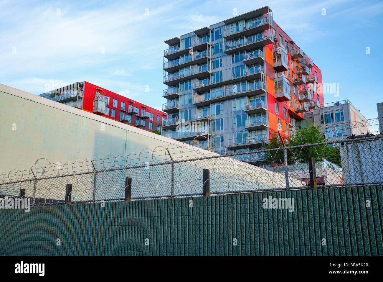The Strathcona Village condo rises above a fence in East Vancouver, BC ...