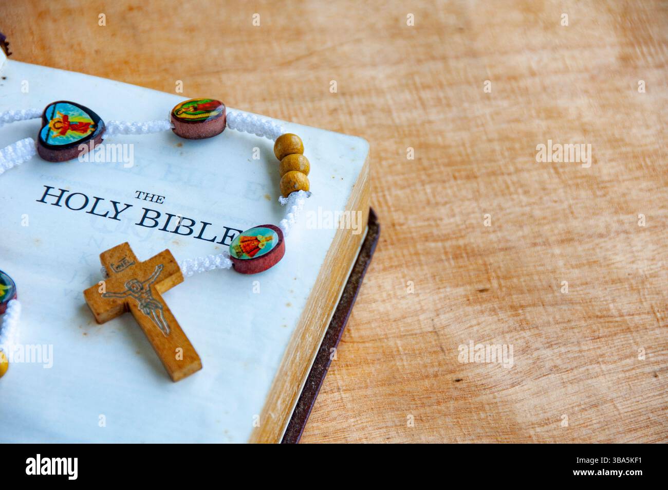 A small wooden cross beside scripture invites deep reflection on Christ ...