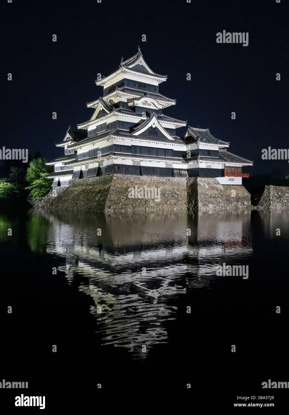 Illuminated by soft lights, Matsumoto Castle stands majestically at ...