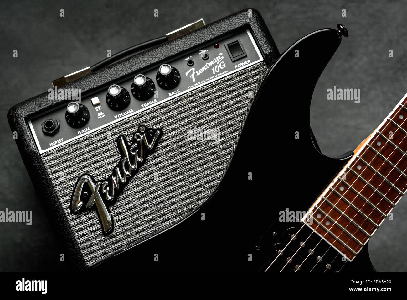 Sound amplifier Fender Frontman 10G and a black electric guitar over ...