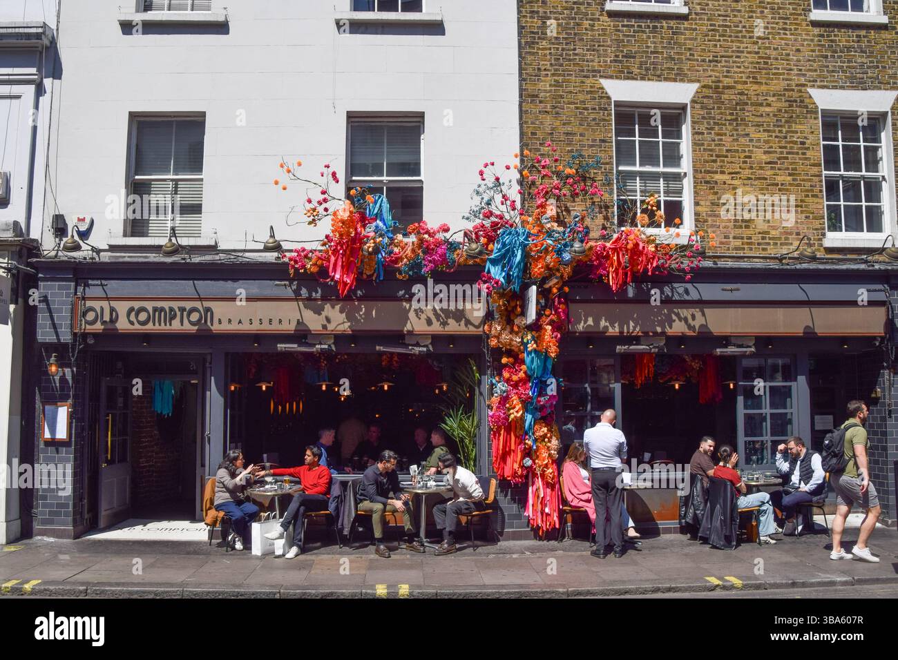 London, UK. 9th May 2025. People sit outside Old Compton Brasserie in ...