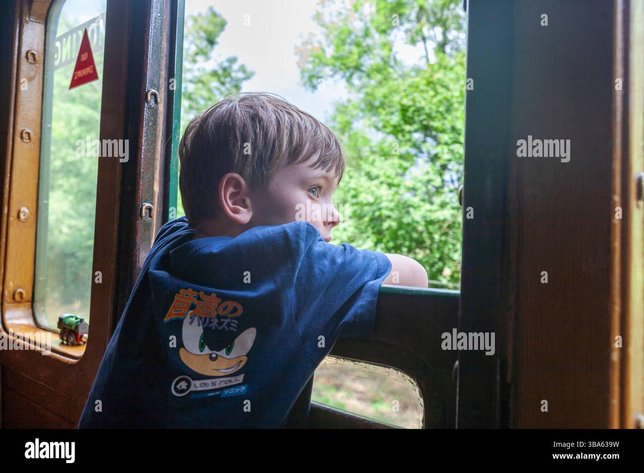 Small boy looks out of the window of a train of the Isle of Wight Steam ...