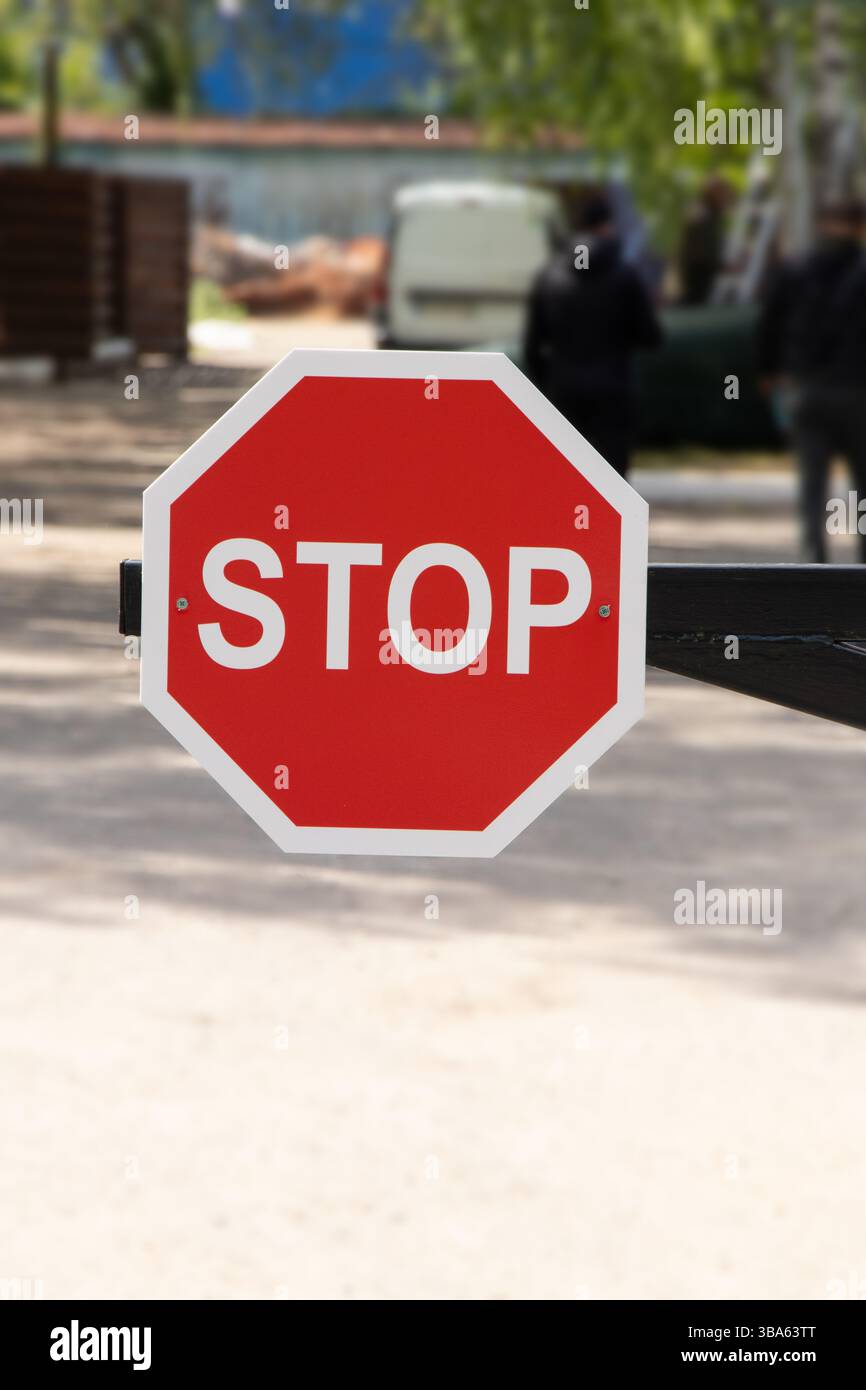 Red STOP sign on a barrier prohibiting entry into the territory in ...