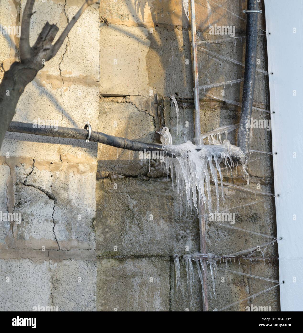 Frozen water after burst from a pipe at the winter Stock Photo - Alamy
