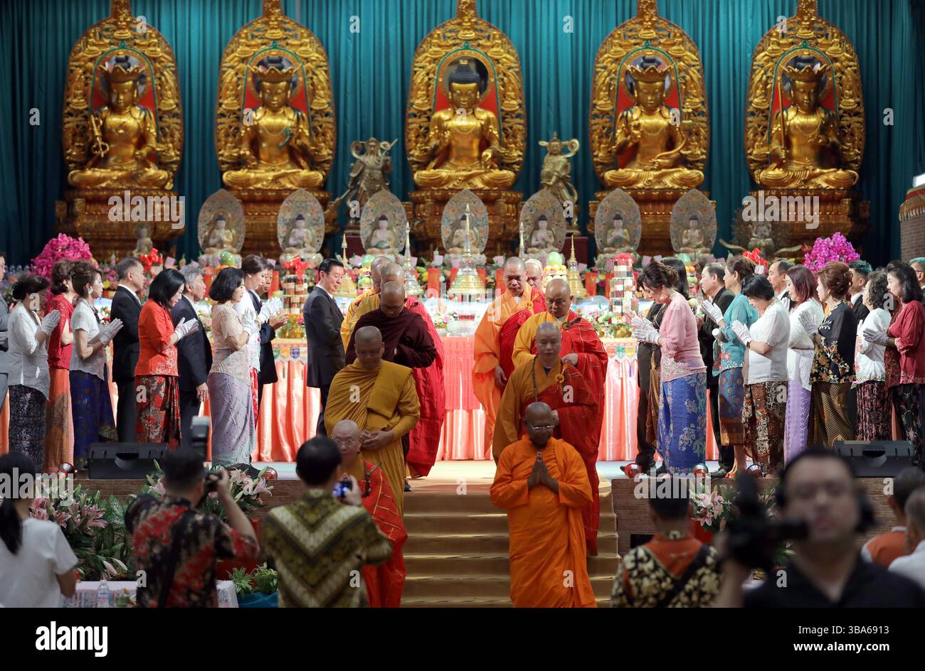 Jakarta, Indonesia.11st May 2025. Devotees pray during a fair to mark ...