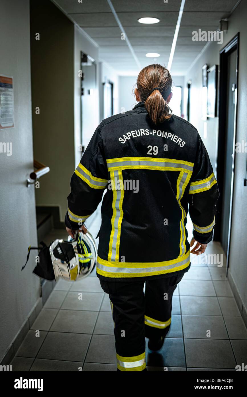 Woman, professional firefighter viewed from behind Stock Photo - Alamy