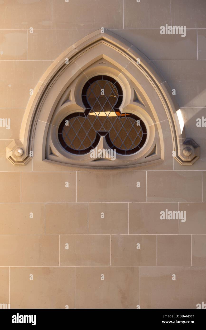 Monochrome trefoil window illuminating a sandstone wall Stock Photo - Alamy