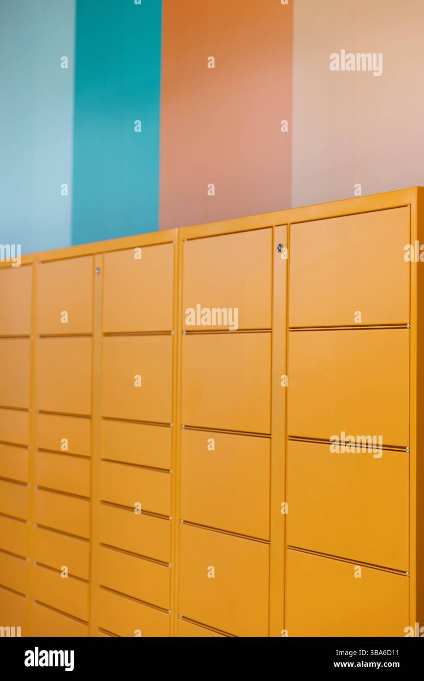 Orange Lockers with vertical pastel stripes on wall - blue pink Stock ...