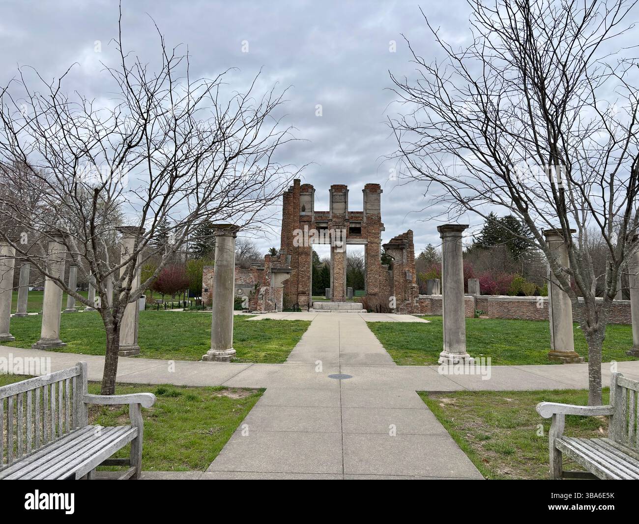 View of historic brick ruins framed by stone columns and trees Stock ...