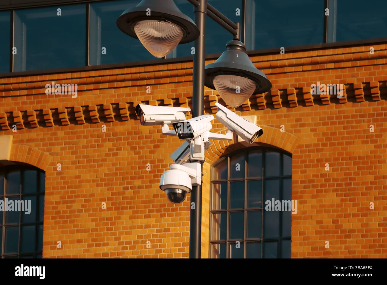 Multiple surveillance cameras on metal pole urban residential ...