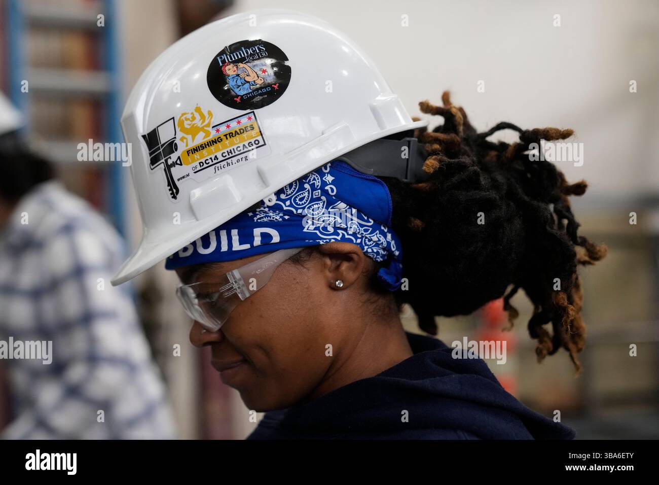 Chyanne Henderson practices putting together a window during an ...