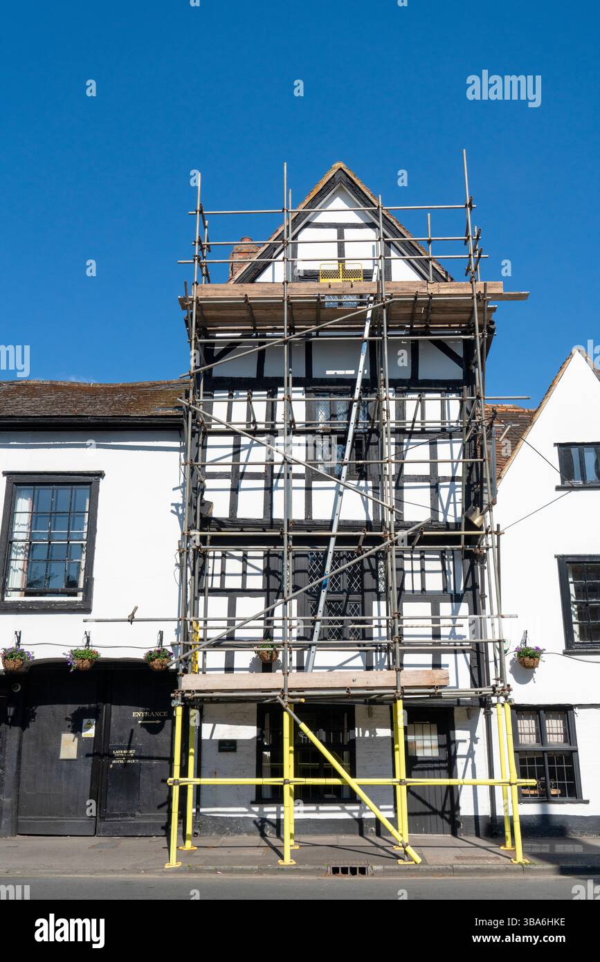Tall Tudor style building covered in scaffolding Stock Photo - Alamy