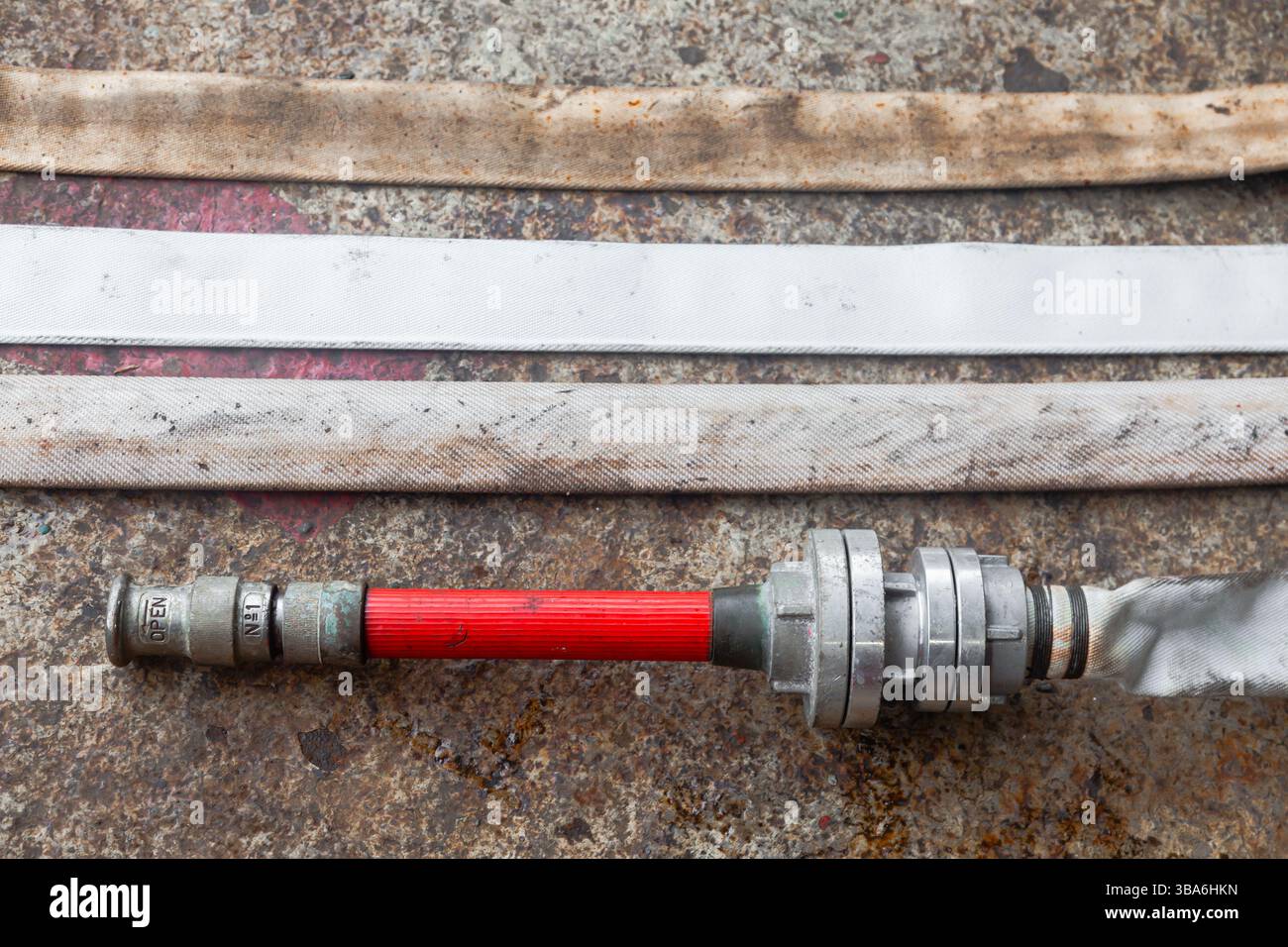 Unwound fire hoses with fire extinguishing tips Stock Photo - Alamy