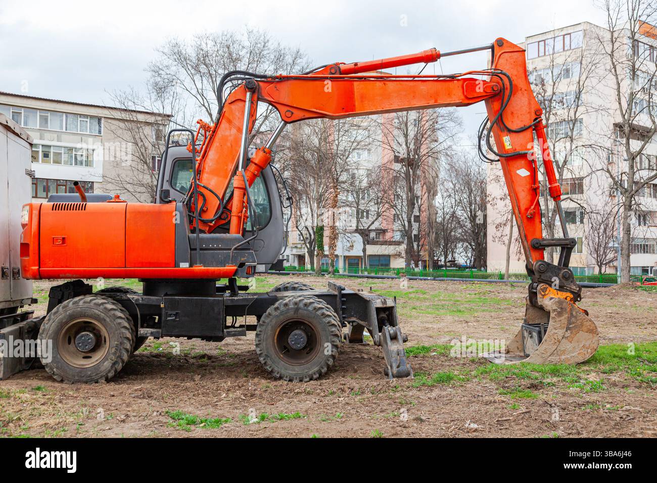 A wheeled excavator stands on the construction site Stock Photo - Alamy