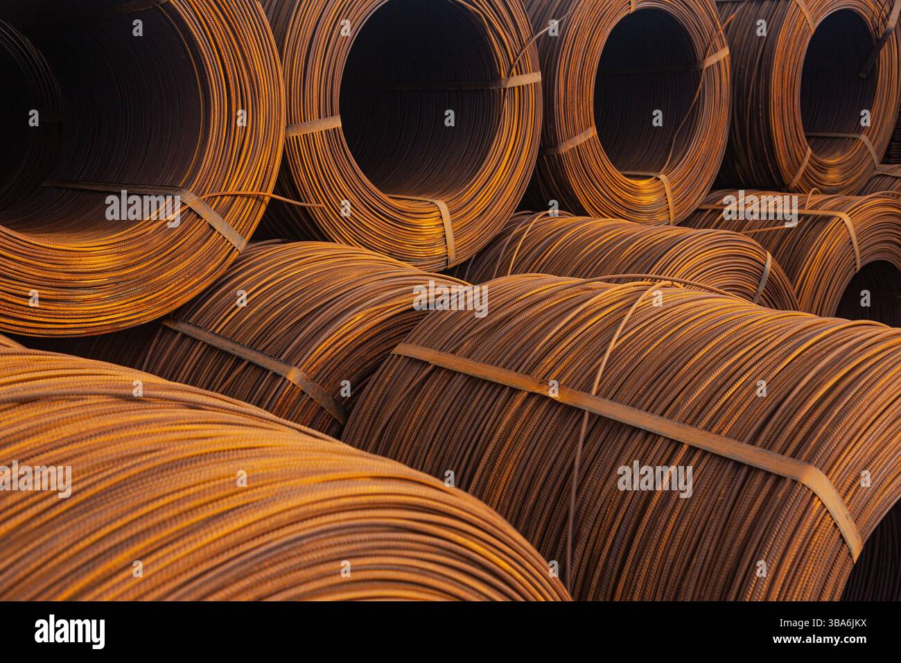 An open-air warehouse with twisted spools of rusty wire Stock Photo - Alamy