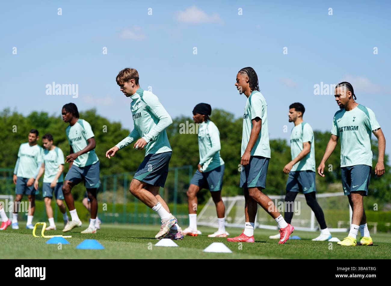 Tottenham Hotspur players warm up during a training session at ...