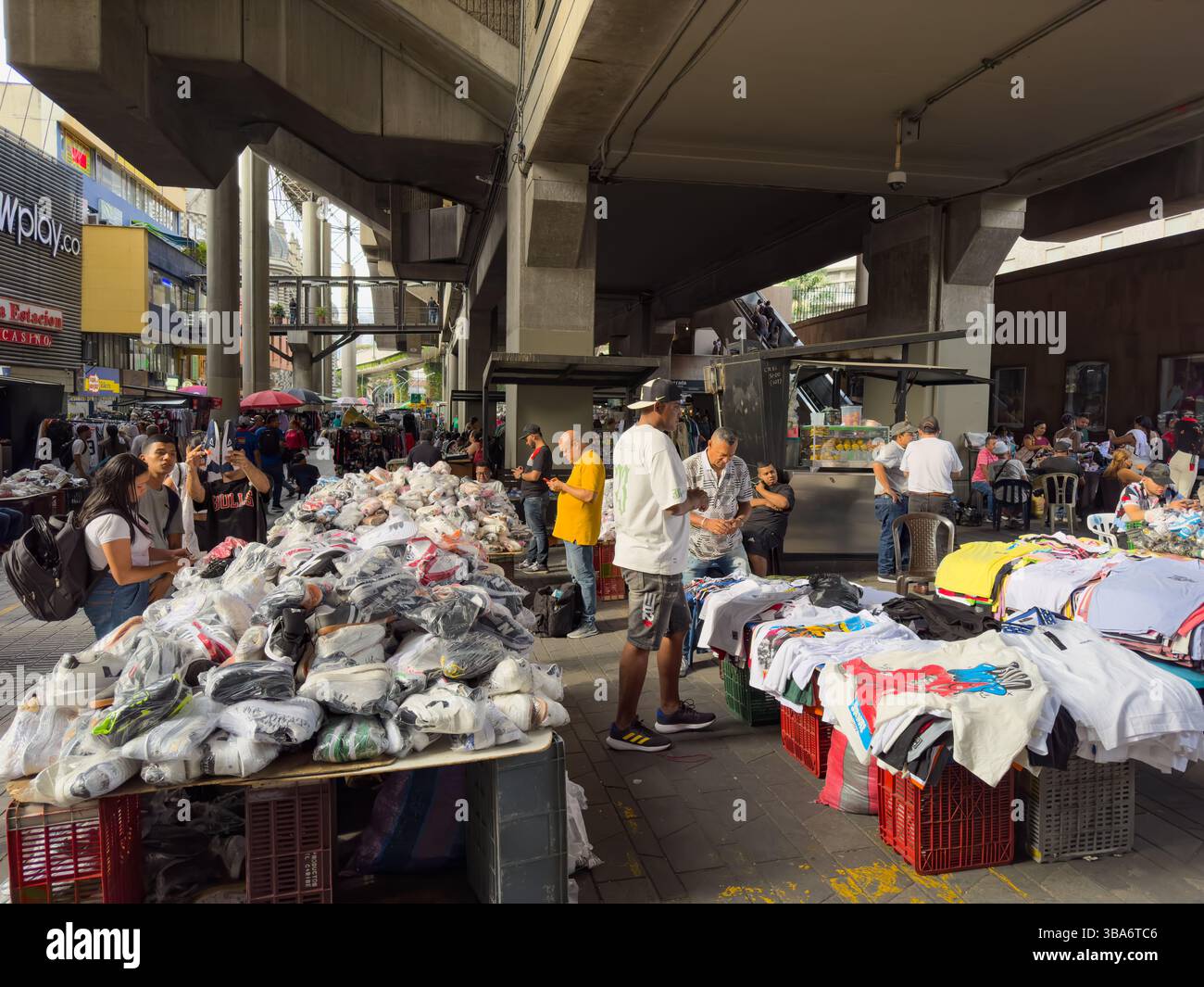 An outdoor open market under the Metro rail line in downtown Medellin ...