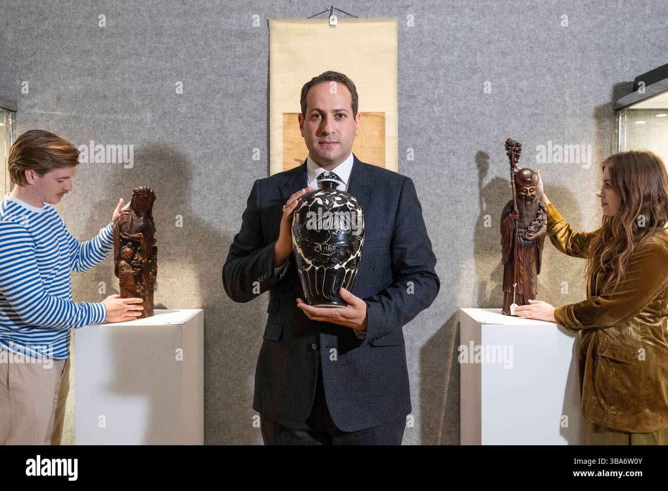 London, UK. 12 May 2025. Staff members with (L to R) 'Large bamboo ...