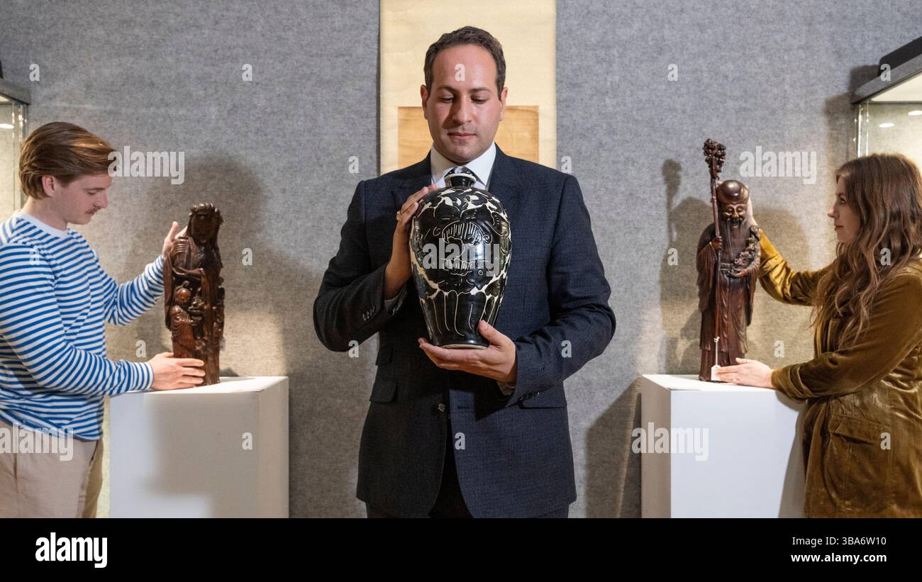 London, UK. 12 May 2025. Staff members with (L to R) 'Large bamboo ...