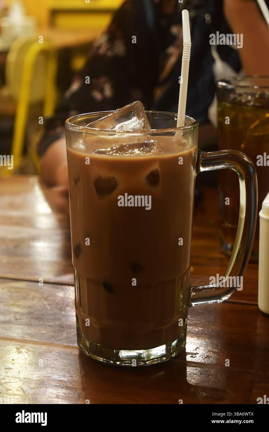 Fresh iced chocolate milk sits on a wooden table in a cafe Stock Photo ...