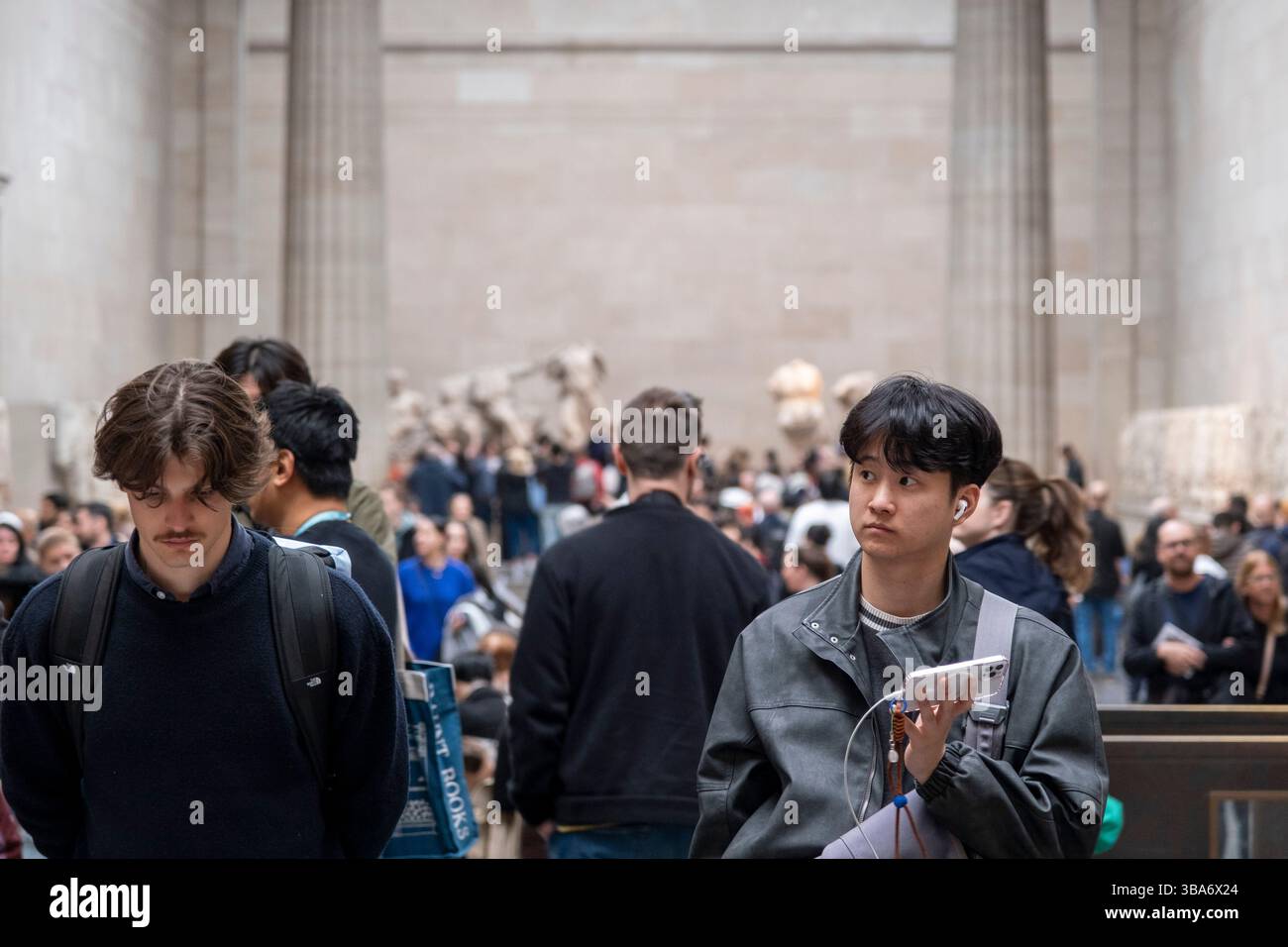 Crowds of visitors gather in the galleries containing the Parthenon ...