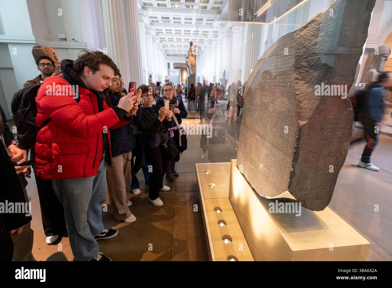 Visitors viewing and takng pictures of the Rosetta Stone at the British ...