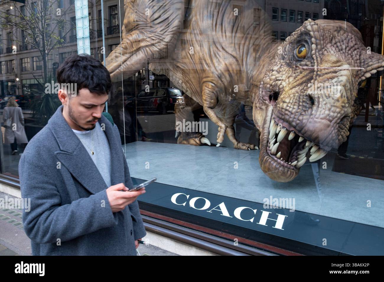 Visitors out on Regent Street pass by a large scale model of a ...