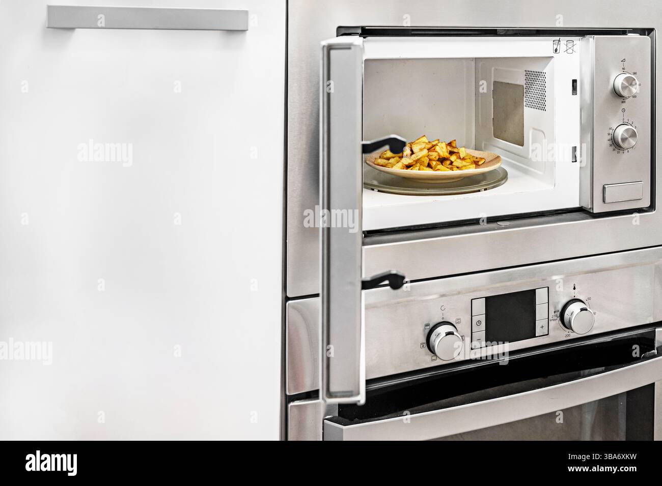 A plate of chips inside a microwave in a kitchen appliance stack Stock ...