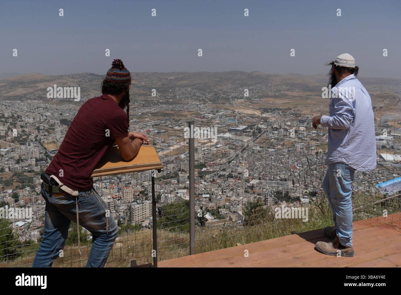 Israeli settlers gazing from an observation point on Mount Gerizim ...