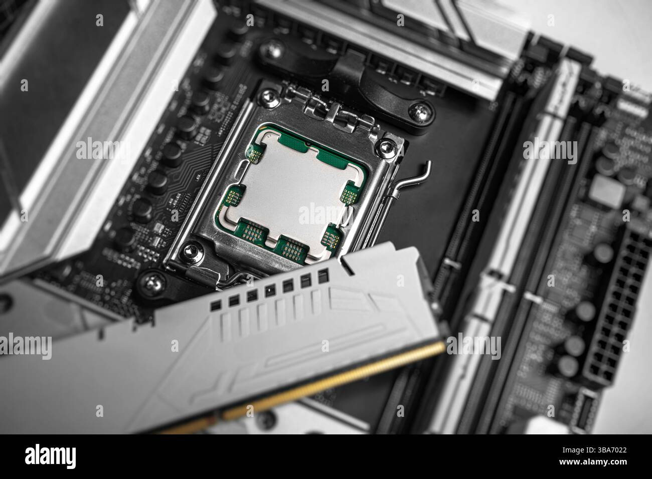 A computer processor is secured in its motherboard socket while a white ...