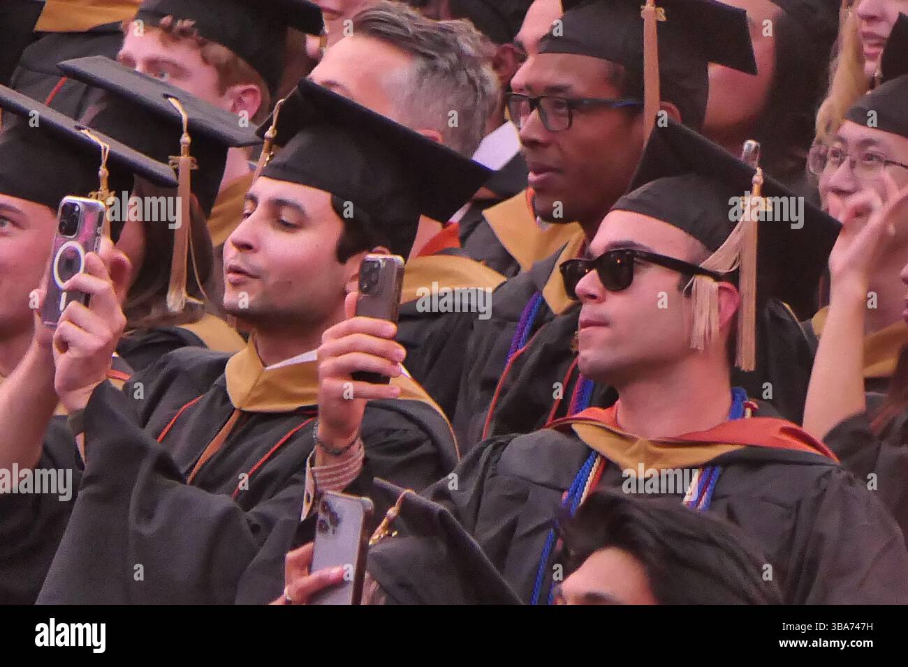 April 26, 2025, Austin, Texas, USA: Graduates stand to be recognized at ...