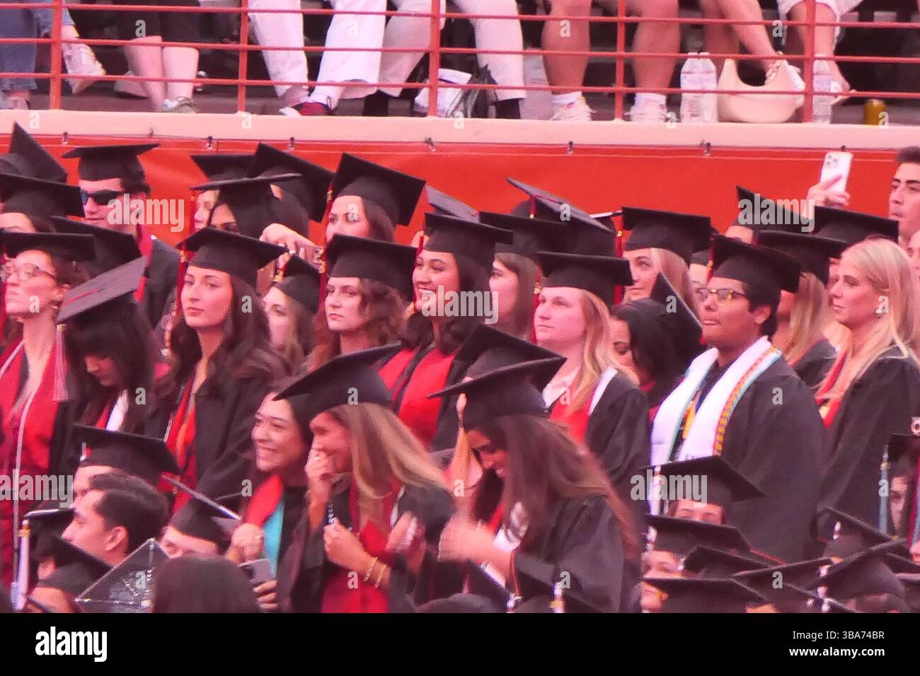 May 10, 2025, Austin, Texas, USA: Graduates stand to be recognized at a ...