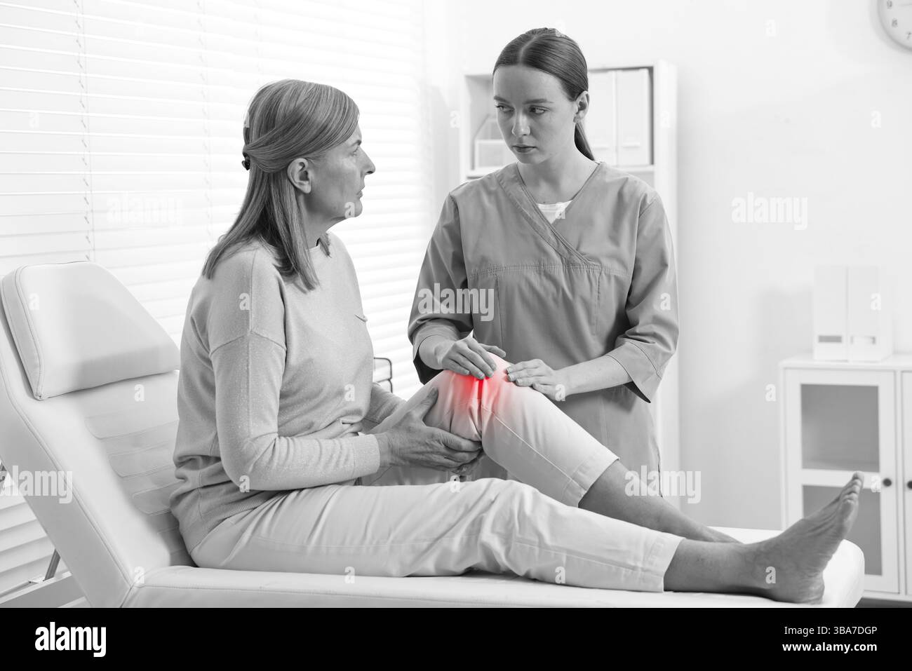 Arthritis. Doctor examining patient with knee pain in hospital. Black ...